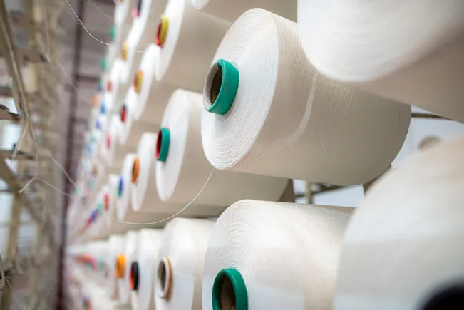 Major fashion brands still rely on synthetic fibers: report | Fashion Dive