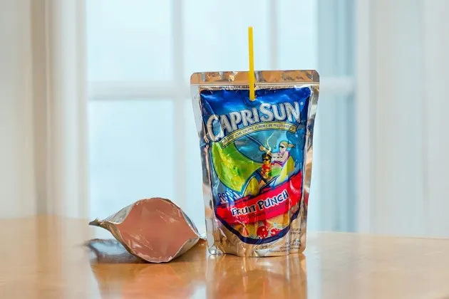 Capri Sun introduces clear bottoms on its foil pouches | Food Dive